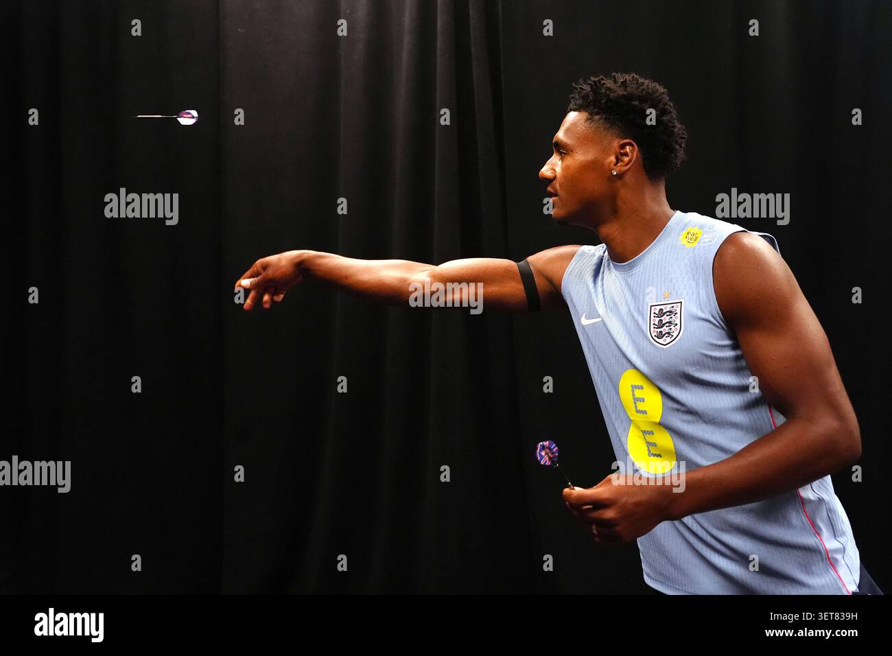 England's Ollie Watkins plays darts during a press conference at Swope ...