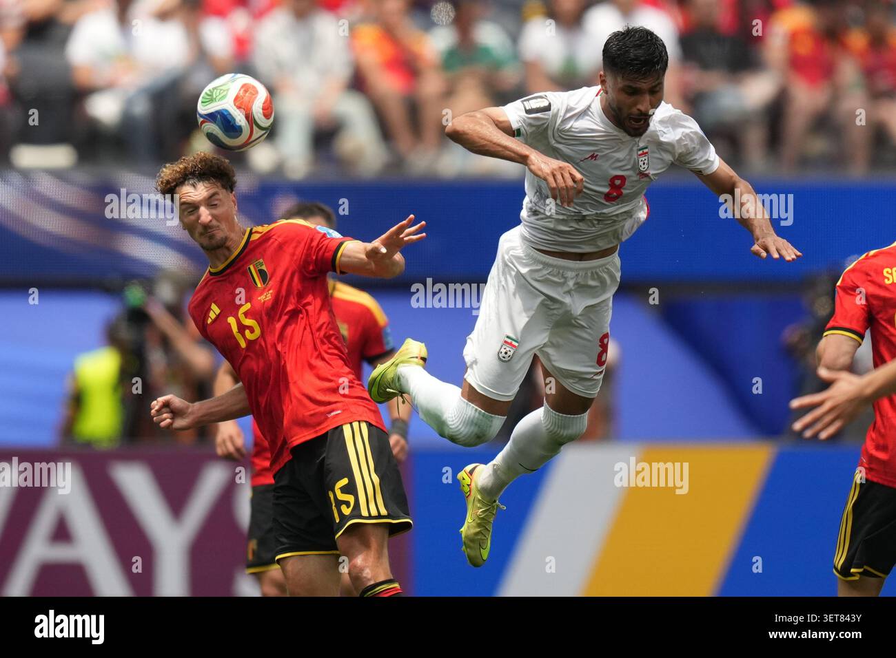 Belgium's Thomas Meunier, left, heads the ball past Iran's Mohammad ...
