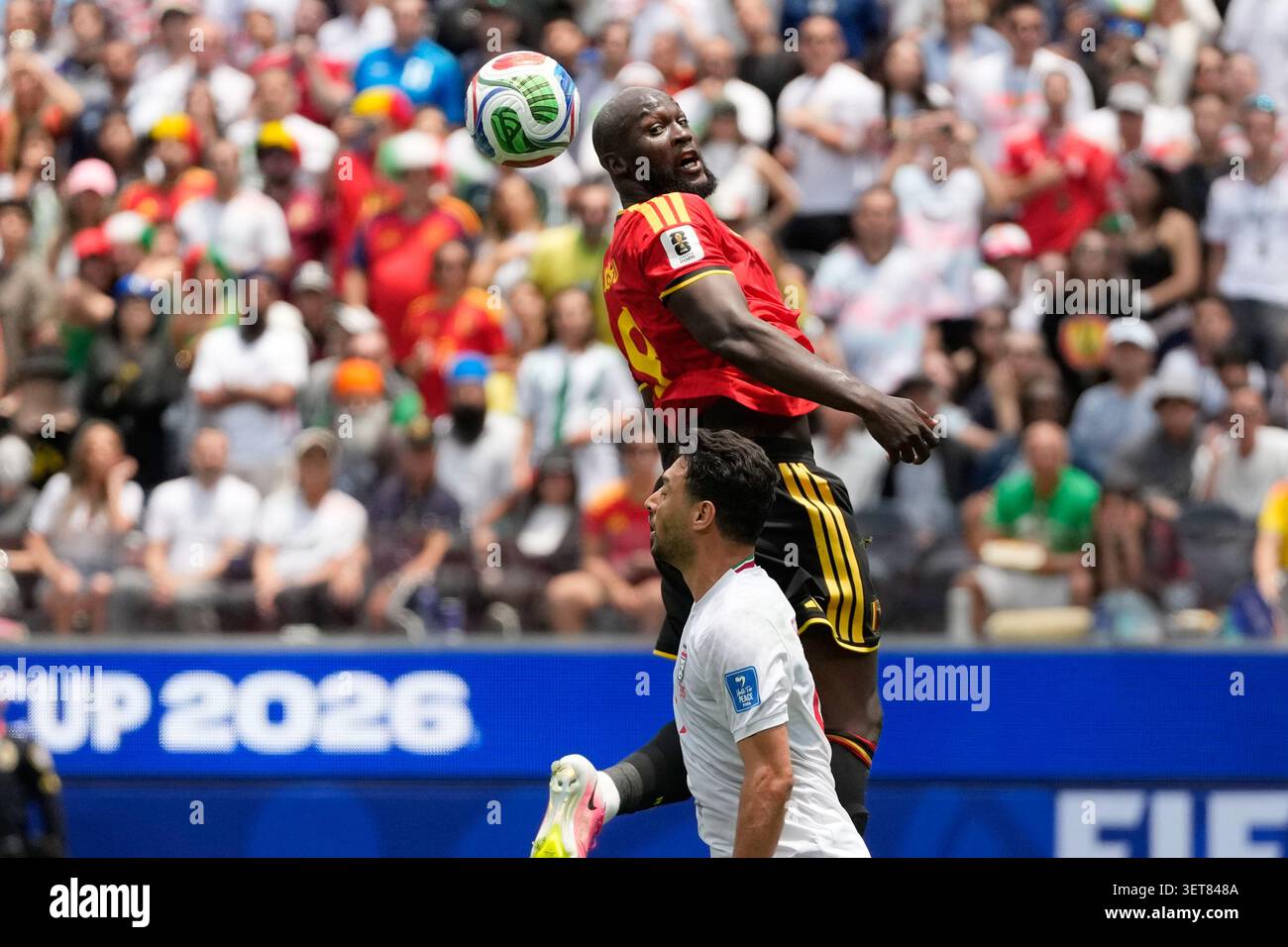 Belgium's Romelu Lukaku, top, jumps for the ball during the World Cup ...