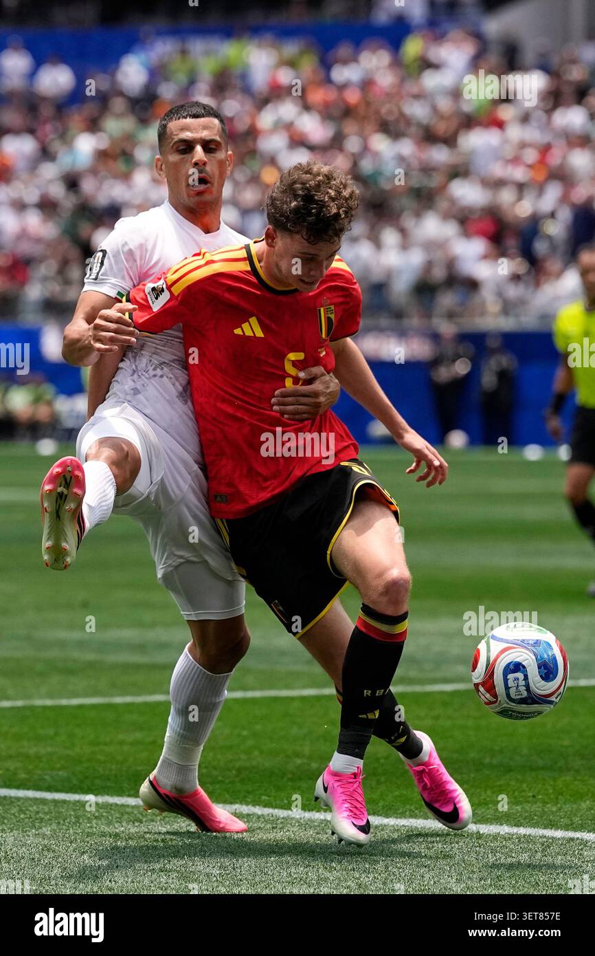 Belgium's Maxim De Cuyper (5), right, fights for the ball with Iran's ...