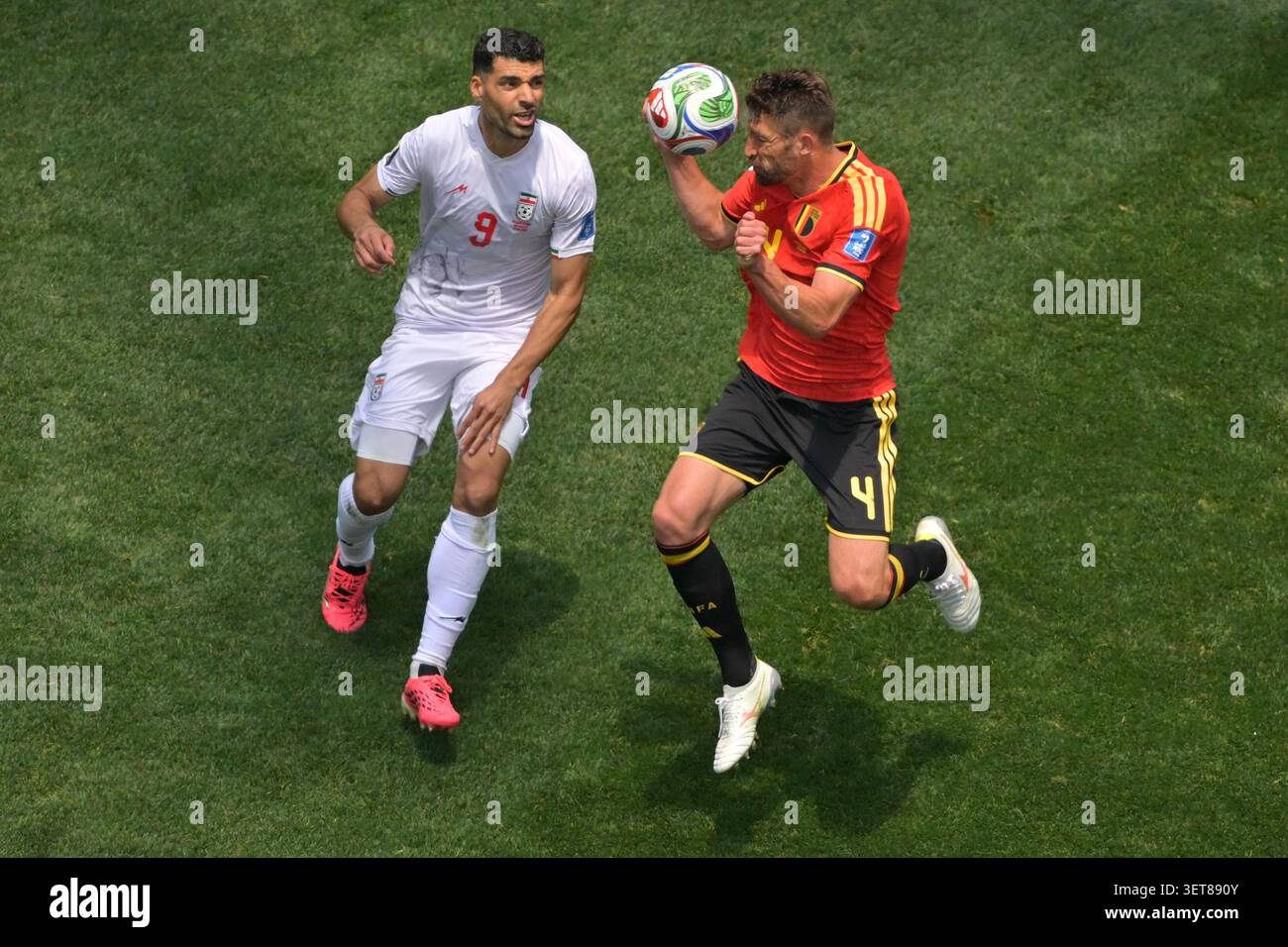 Belgium's Brandon Mechele (4) clears the ball in front of Iran's Mehdi ...