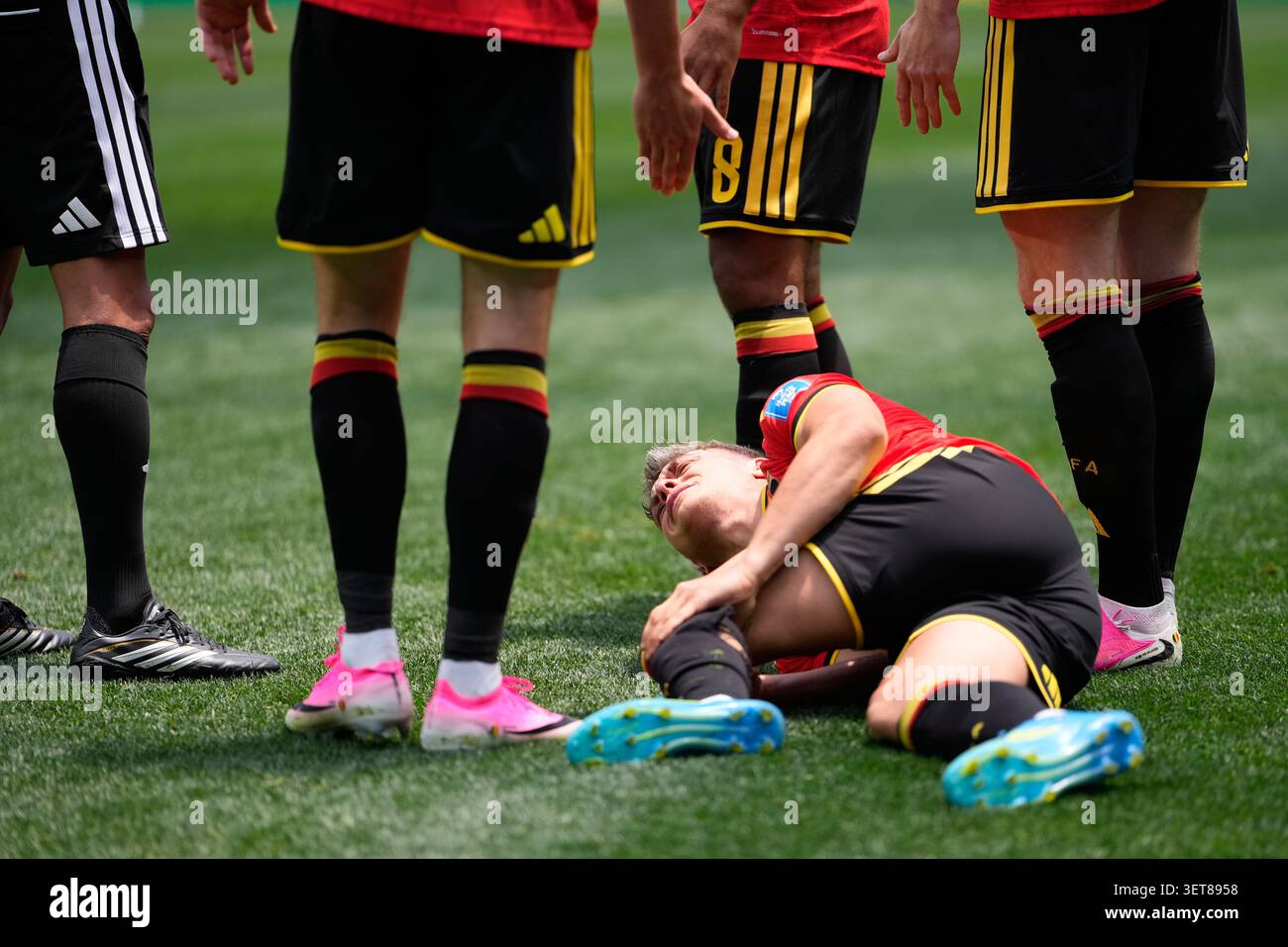Belgium's Leandro Trossard grimaces in pain during the World Cup Group ...