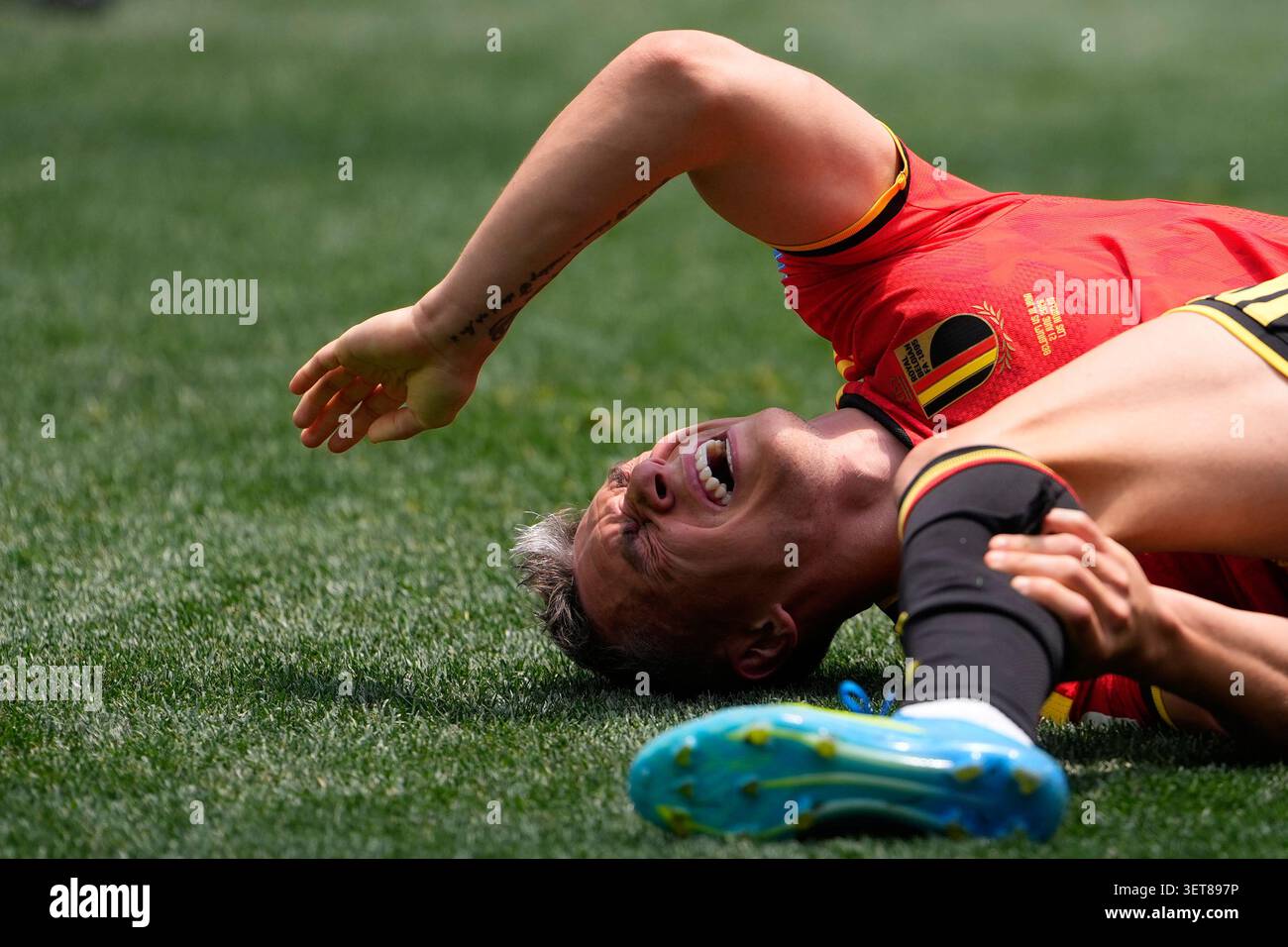 Belgium's Leandro Trossard grimaces in pain during the World Cup Group ...