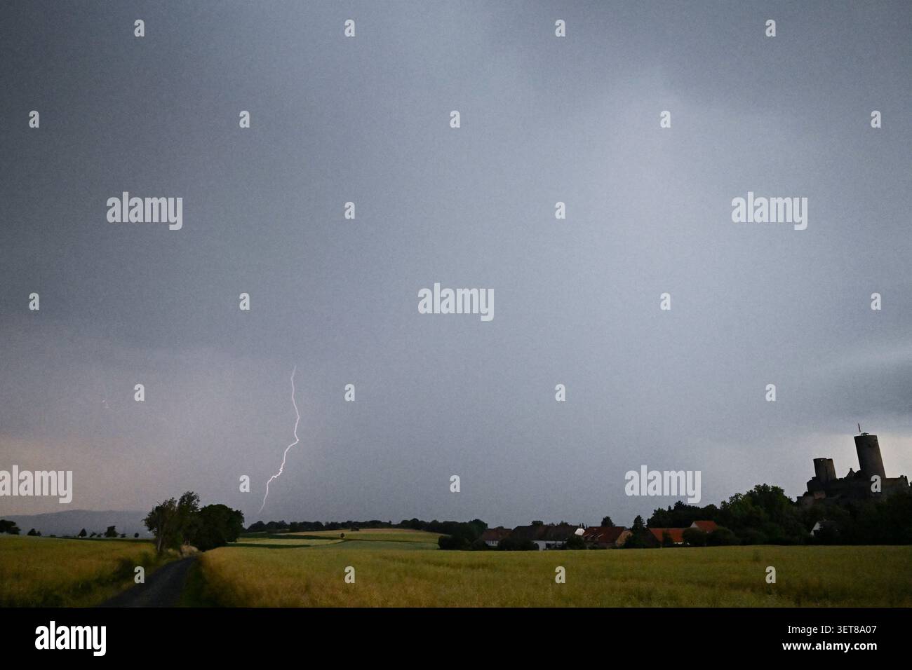 21 June 2026, Hesse, Münzenberg: A flash of lightning illuminates the ...
