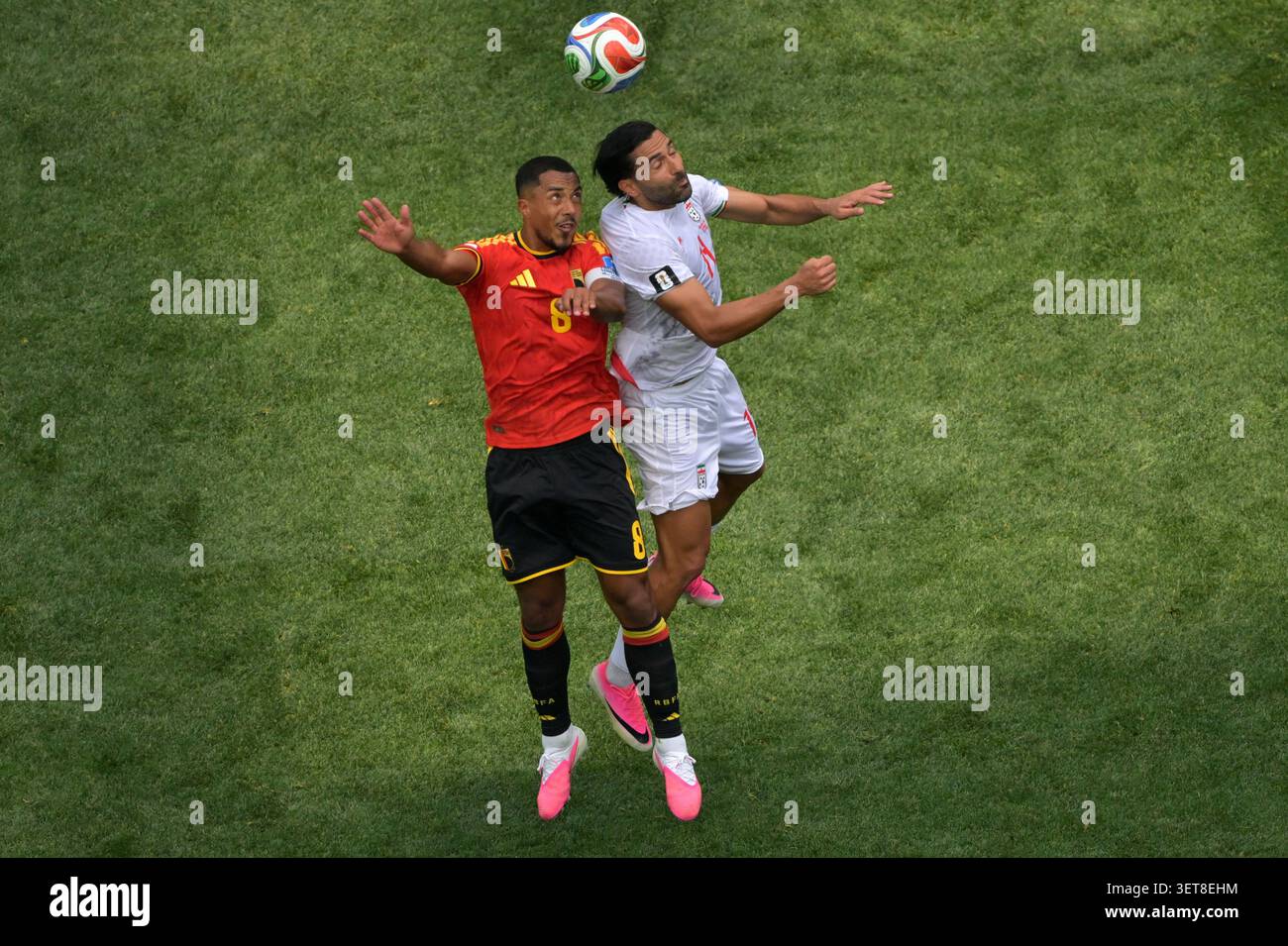 Belgium's Youri Tielemans (8) and Iran's Saman Ghoddos (14) jump for ...