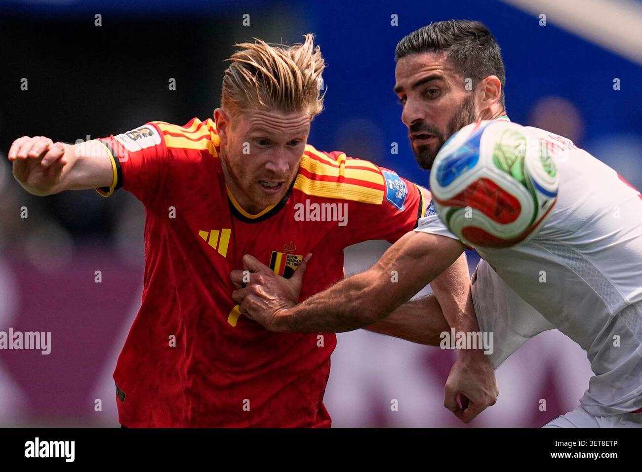 Belgium's Kevin De Bruyne (7), fights for the ball with Iran's Milad ...