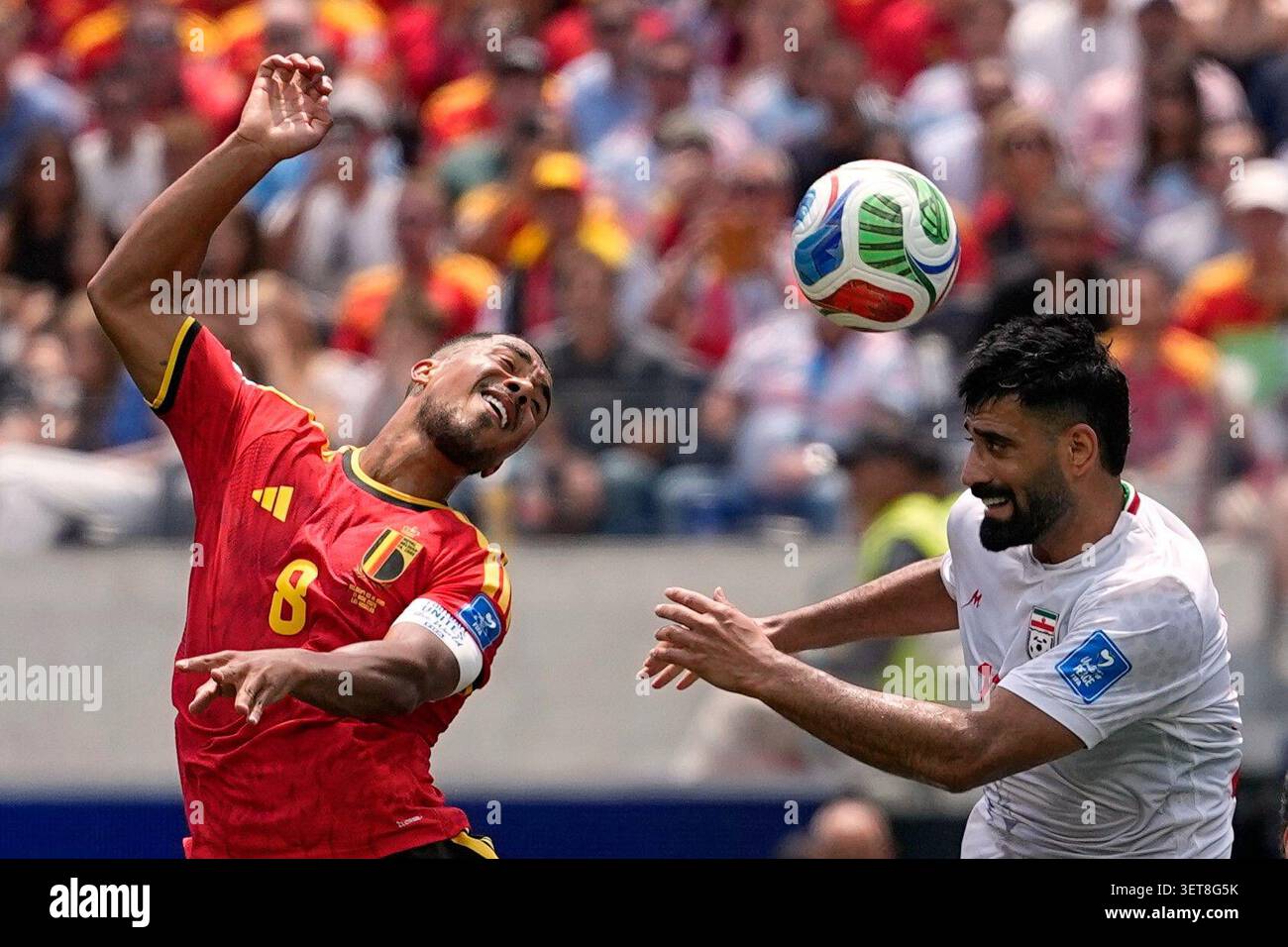 Belgium's Youri Tielemans (8), left, heads for the ball with Iran's ...