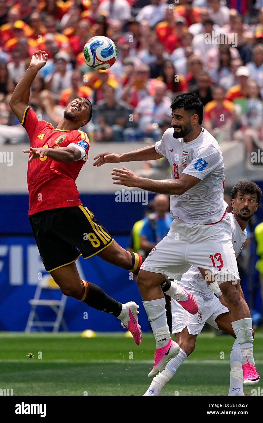Belgium's Youri Tielemans (8), left, heads for the ball with Iran's ...