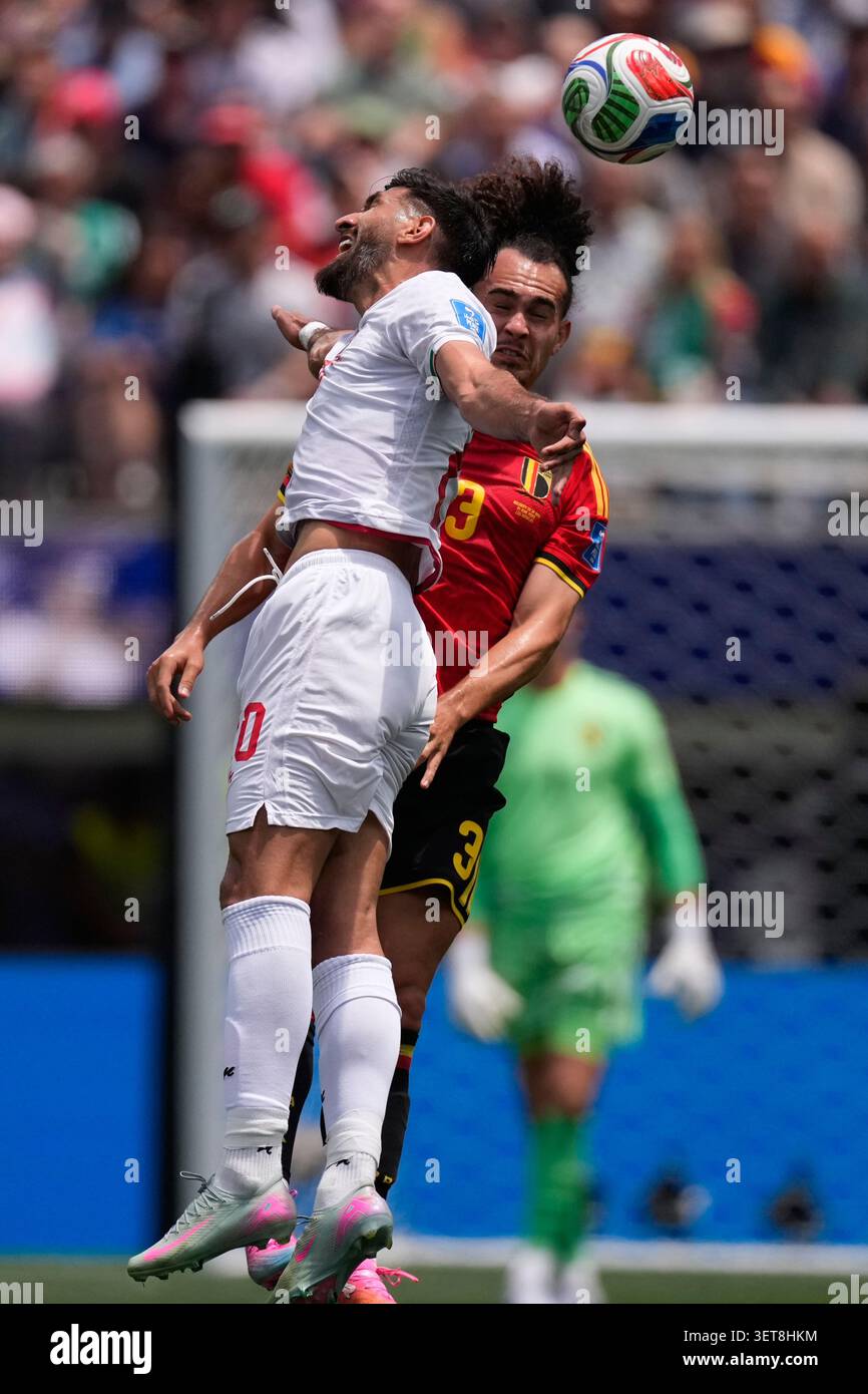 Iran's Shahriyar Moghanloo, left, and Belgium's Arthur Theate go for a ...