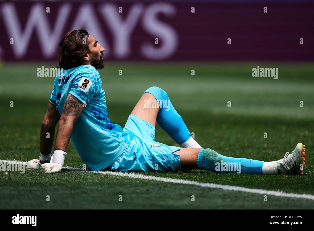 Iran goalkeeper Alireza Beiranvand sits on the field at the end of the ...