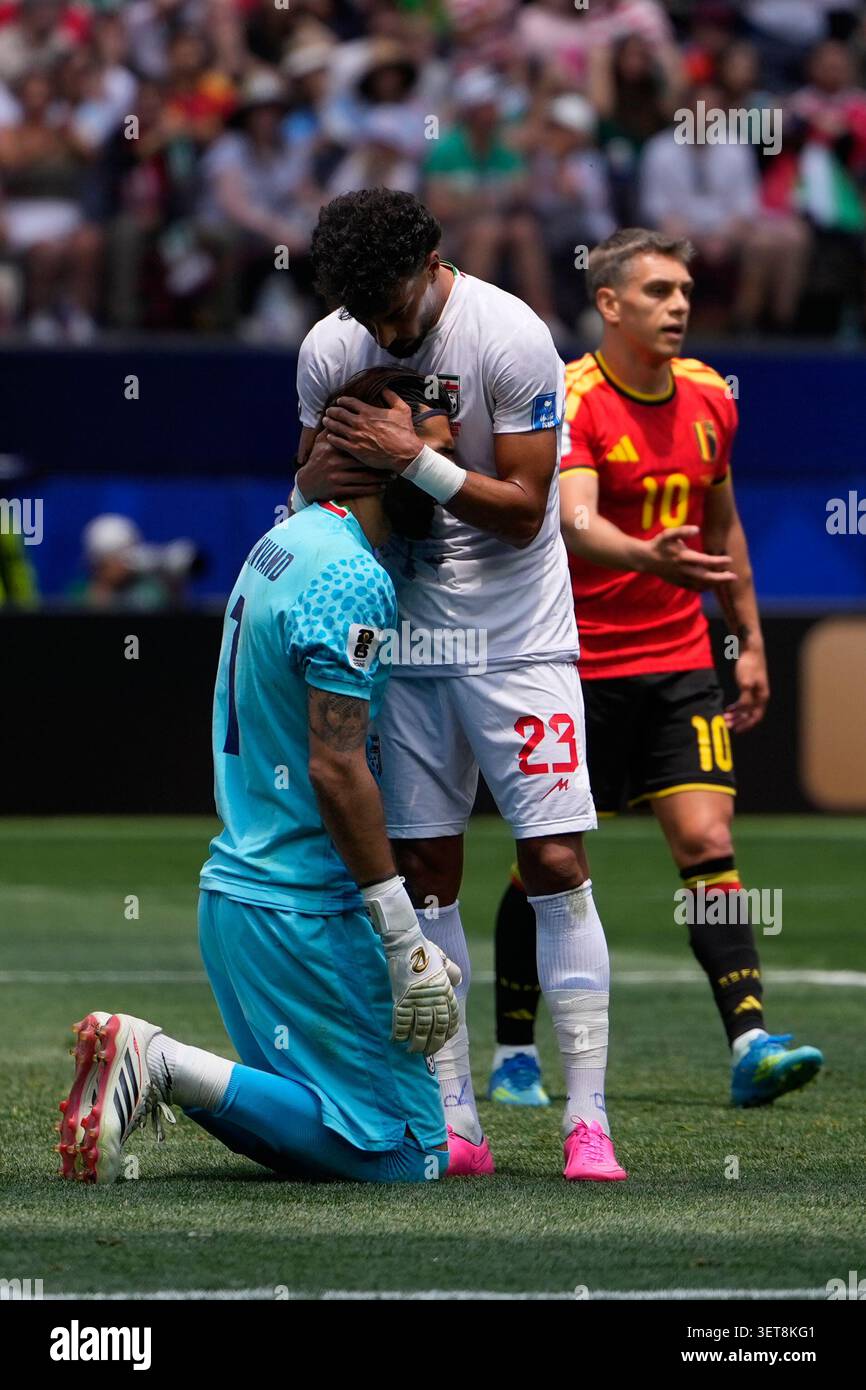 Iran's Ramin Rezaeian (23) embraces Alireza Beiranvand during the World ...