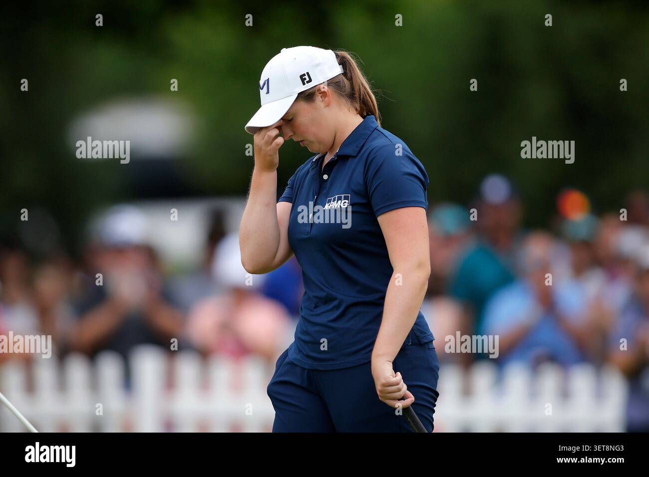 Lottie Woad, of England, reacts after missing a putt on the 18th hole ...