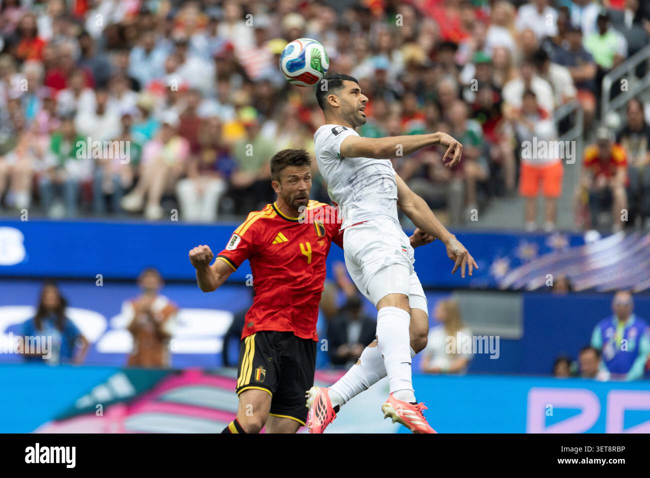 IR Iran' Mohammad Mohebbi (8) heads the ball against Belgium' Brandon ...