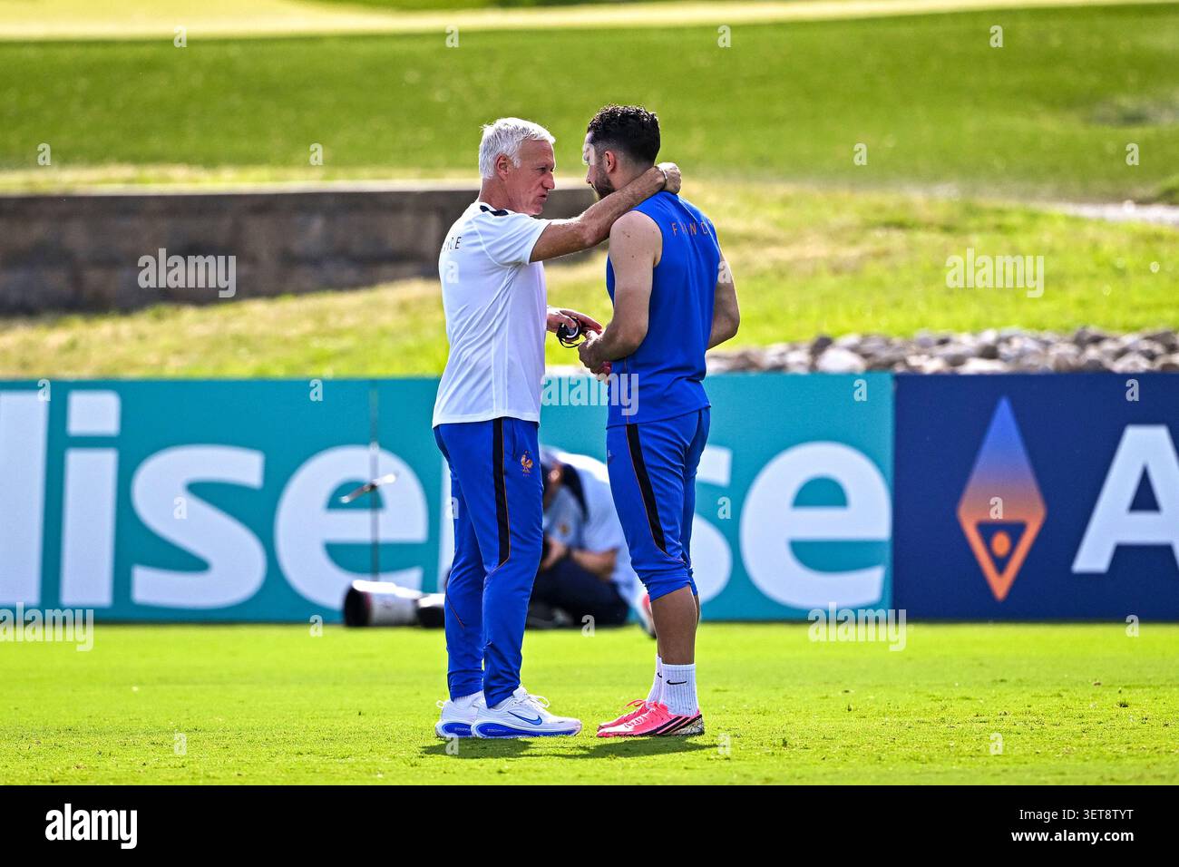 France's head coach Didier DESCHAMPS speaks with France's Rayan CHERKI ...