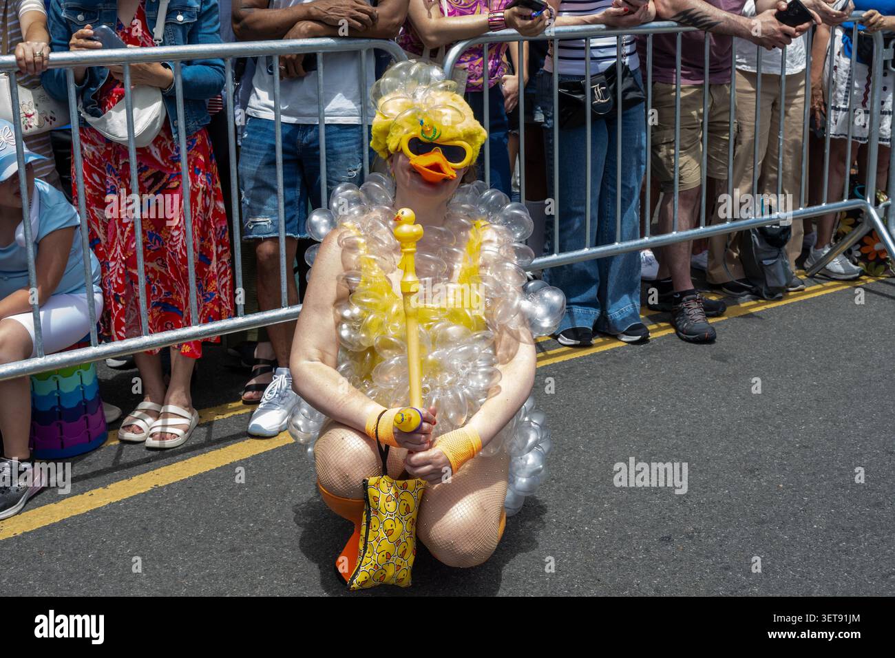 A reveler dressed as a rubber ducky in a bathtub participates in the ...