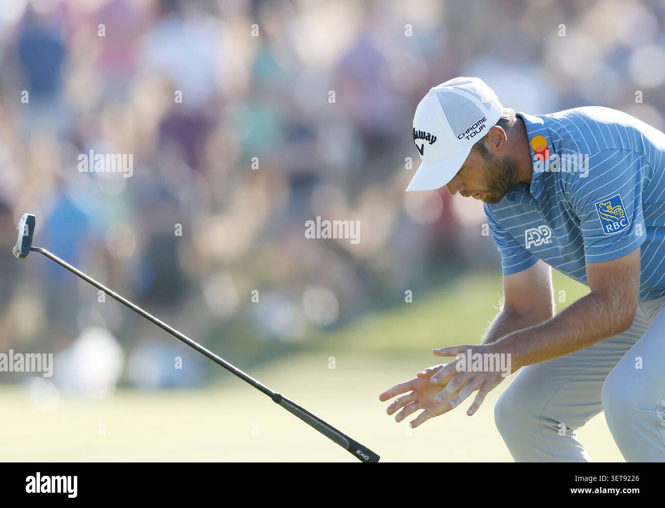 Sam Burns throws his club after missing a putt on the 18th hole during ...