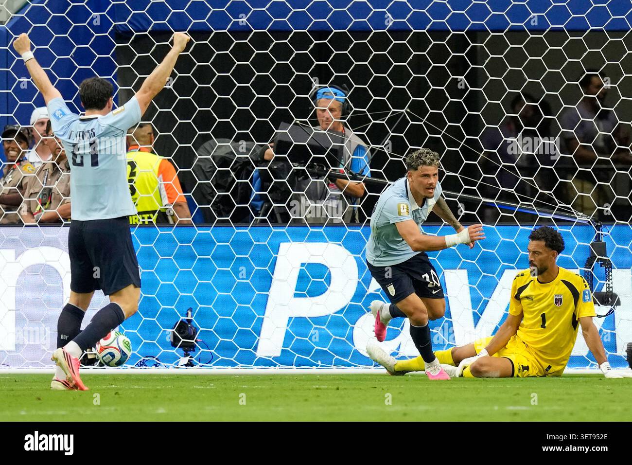 Uruguay's Maxi Araujo, centre, reacts after scoring his team's first ...