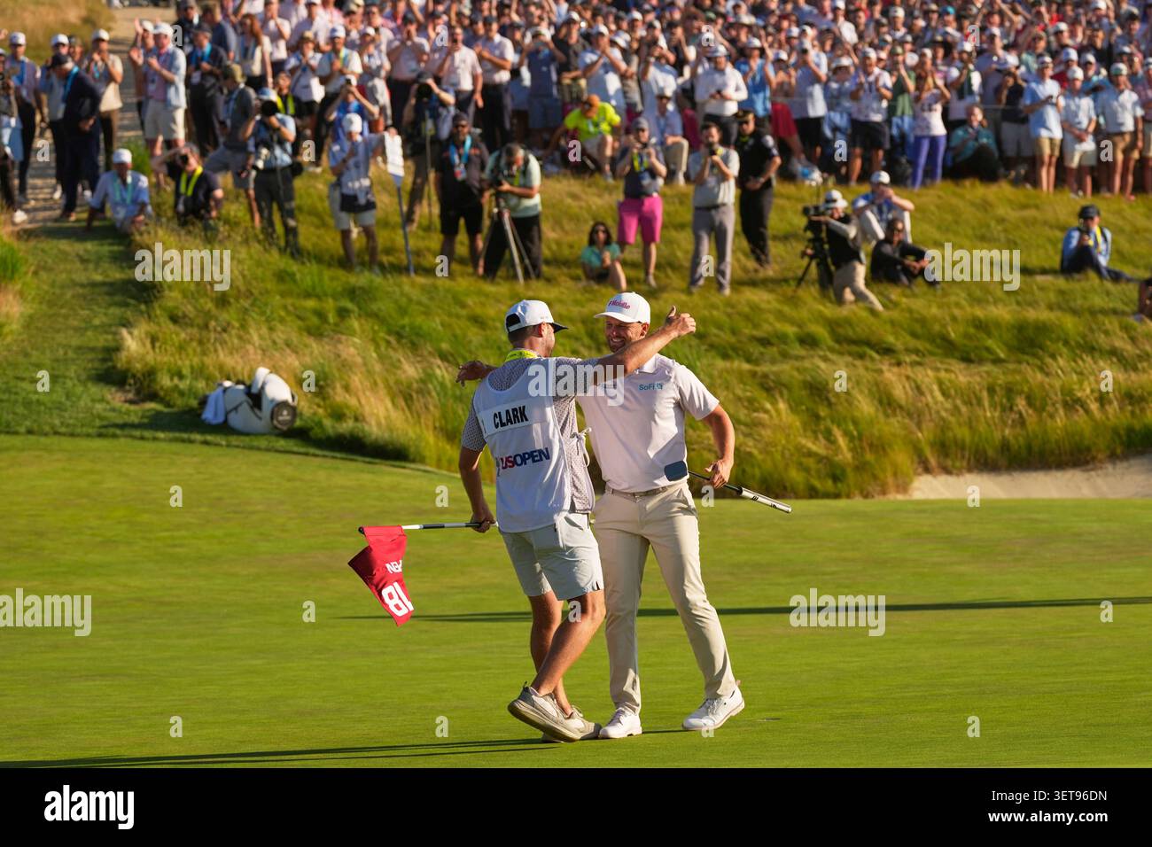 Wyndham Clark celebrates with his caddie David Pelekoudas after winning ...