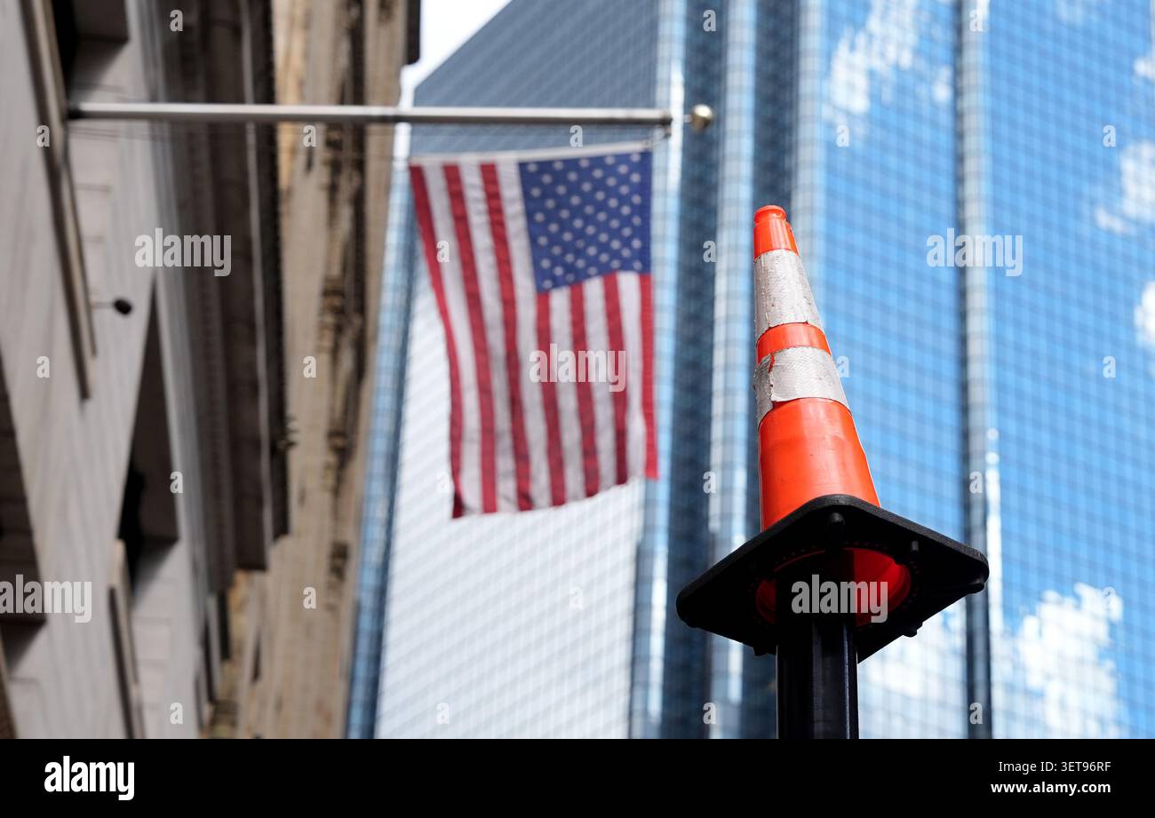A cone sits on top of a traffic sign in Boston. Orange traffic cones ...