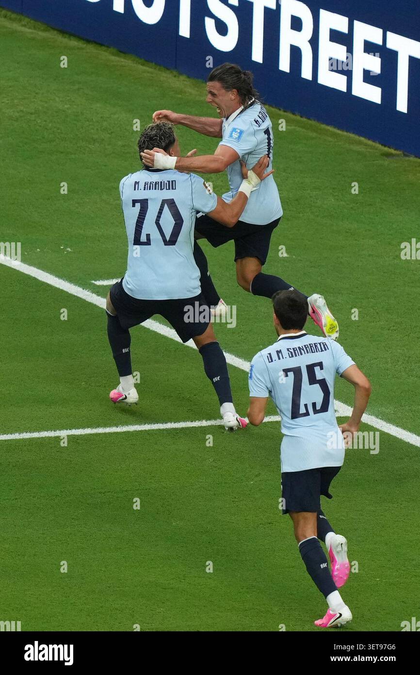 Uruguay's Agustin Canobbio, top, celebrates after scoring his side's ...