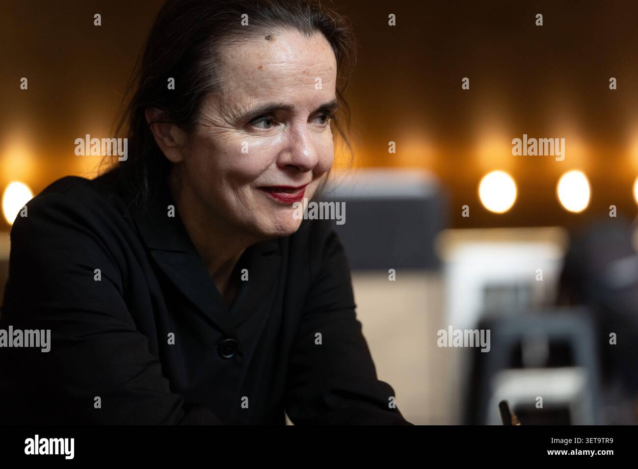 Amelie Nothomb smiles while listening to a fan at the book signing ...
