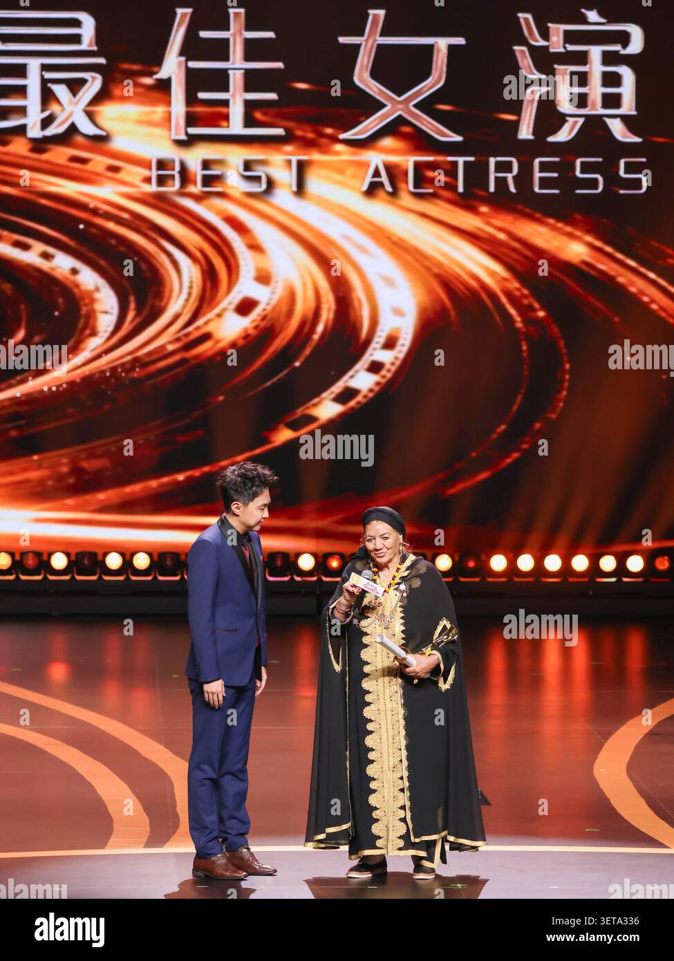 Khadija Amari receives the Best Actress award from Xin Zhilei and Zhang ...