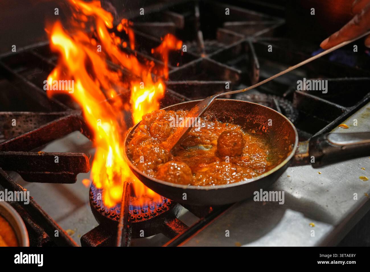 Chef Mohammed Shanoor Ali cooks at a Bangladeshi restaurant in London ...