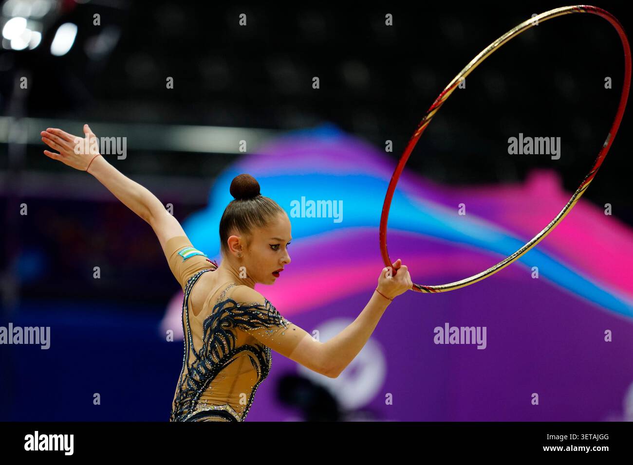 Sevinch Muminova of Uzbekistan performs her hoop routine during ...