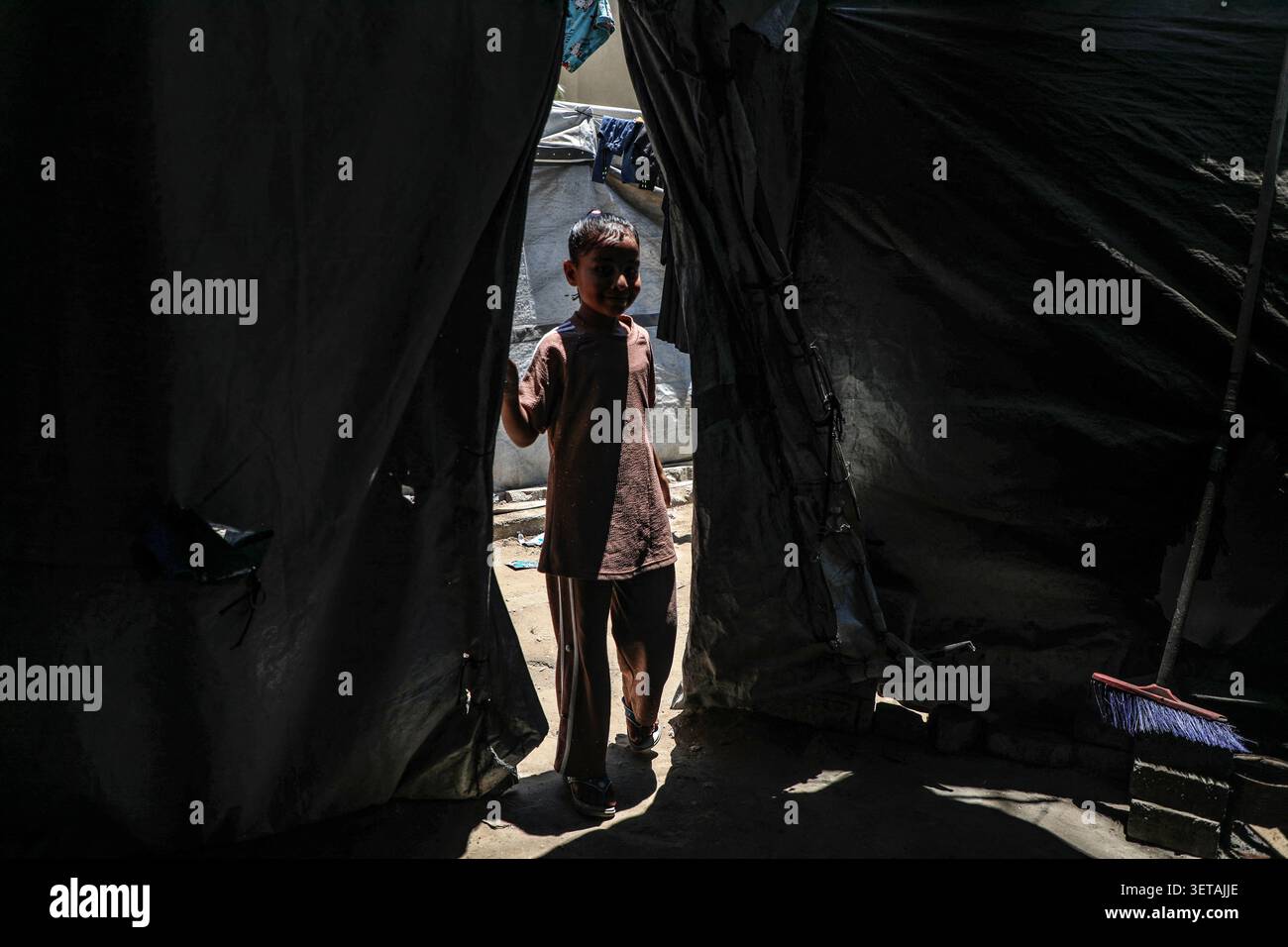 Palestinian children bathe in their tent inside a displacement camp in ...