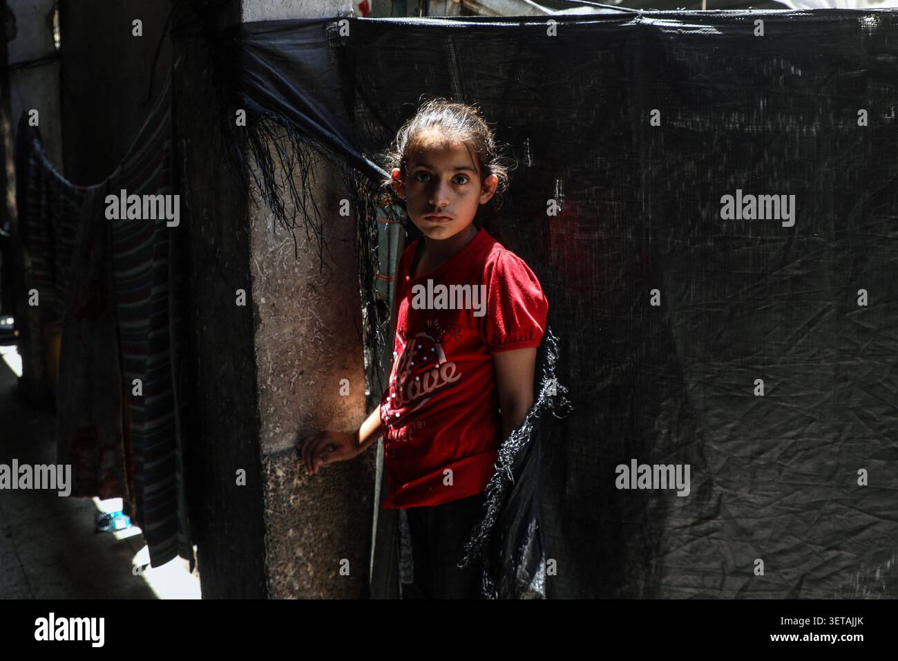 Palestinian children bathe in their tent inside a displacement camp in ...