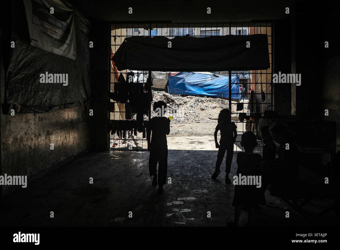 Palestinian children bathe in their tent inside a displacement camp in ...