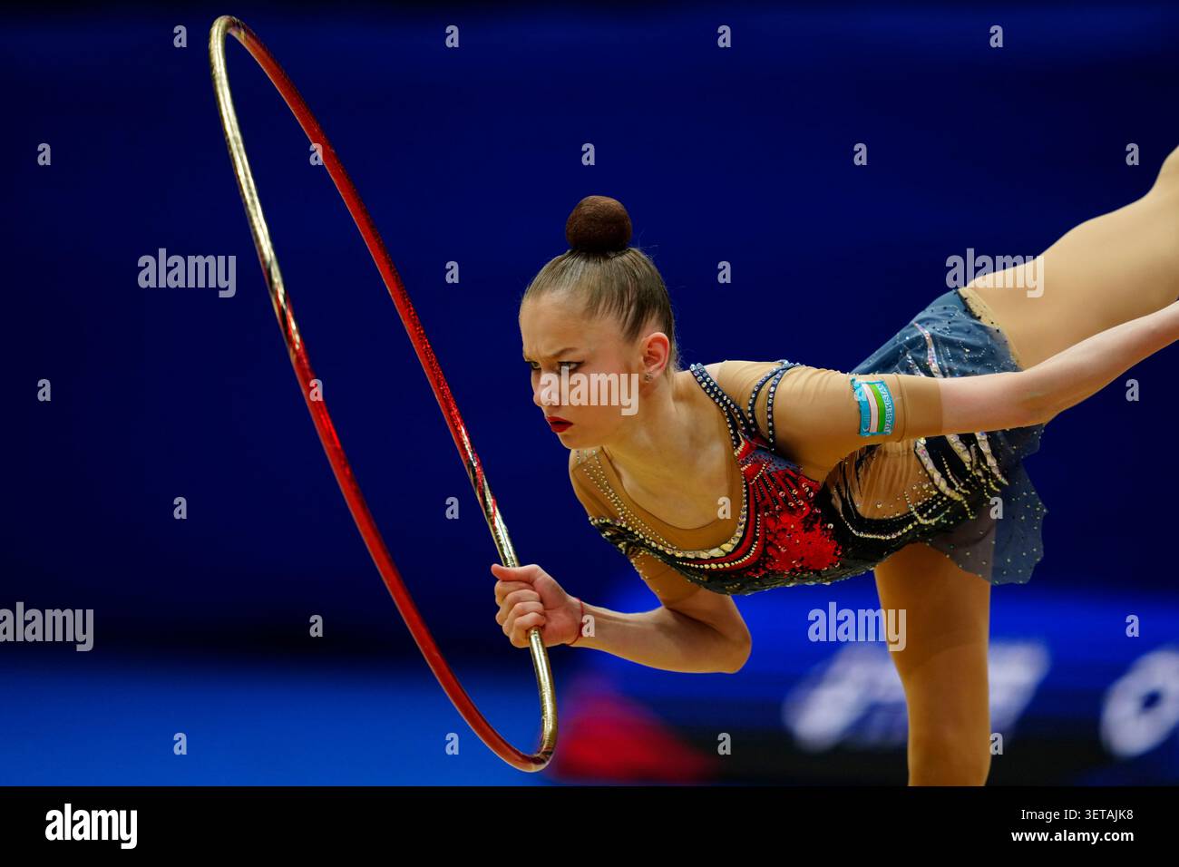 Sevinch Muminova of Uzbekistan performs her hoop routine during ...