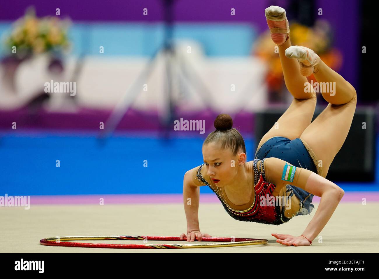 Sevinch Muminova of Uzbekistan performs her hoop routine during ...