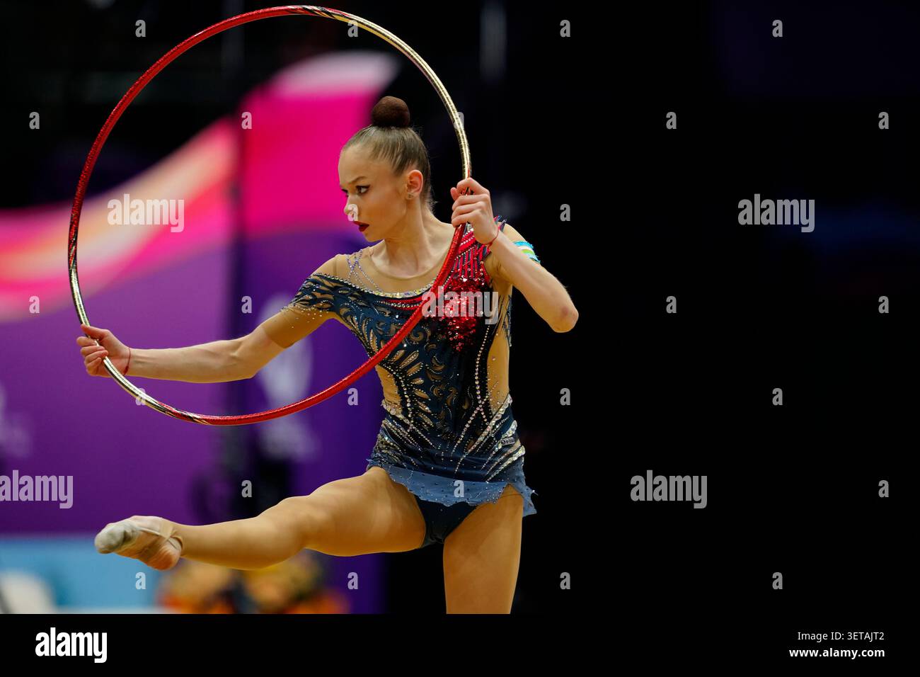 Sevinch Muminova of Uzbekistan performs her hoop routine during ...