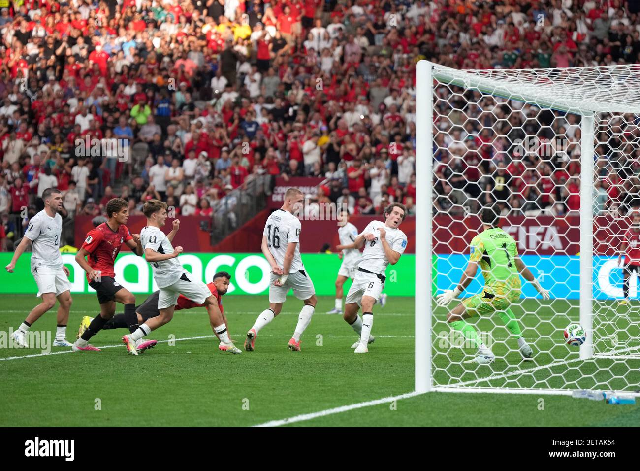 Egypt's Mahmoud Hassan Trezeguet (7) scores on New Zealand's Max ...
