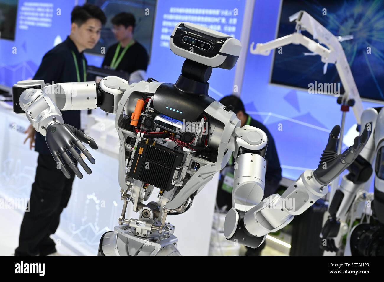 22 June 2026, China, Peking: Humanoid robots dance at a booth during ...