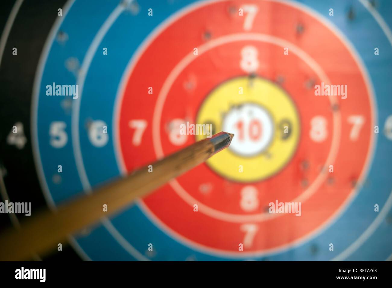 An arrow flies towards the archery target, the bulls eye. Shallow focus ...