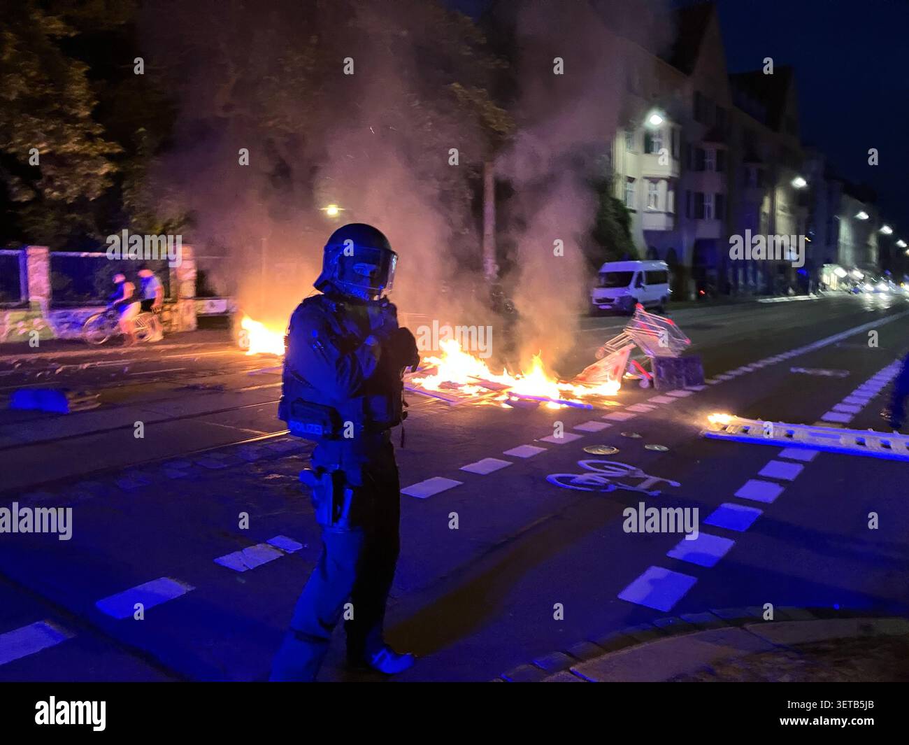 21 June 2026, Saxony, Leipzig: A police officer stands in front of a ...