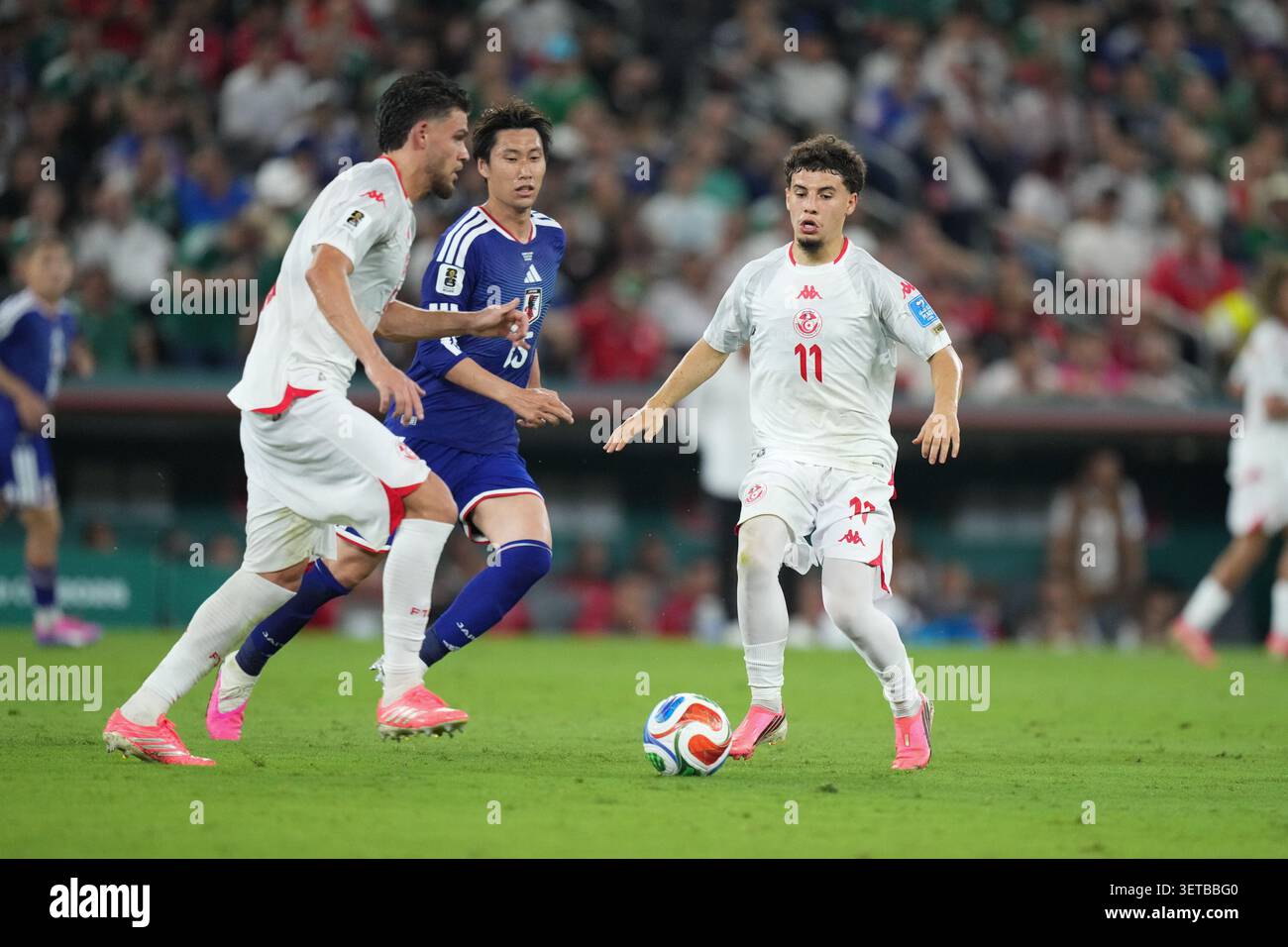 Ismael Gharbi of Tunisia and Daichi Kamada of Japan during the FIFA ...