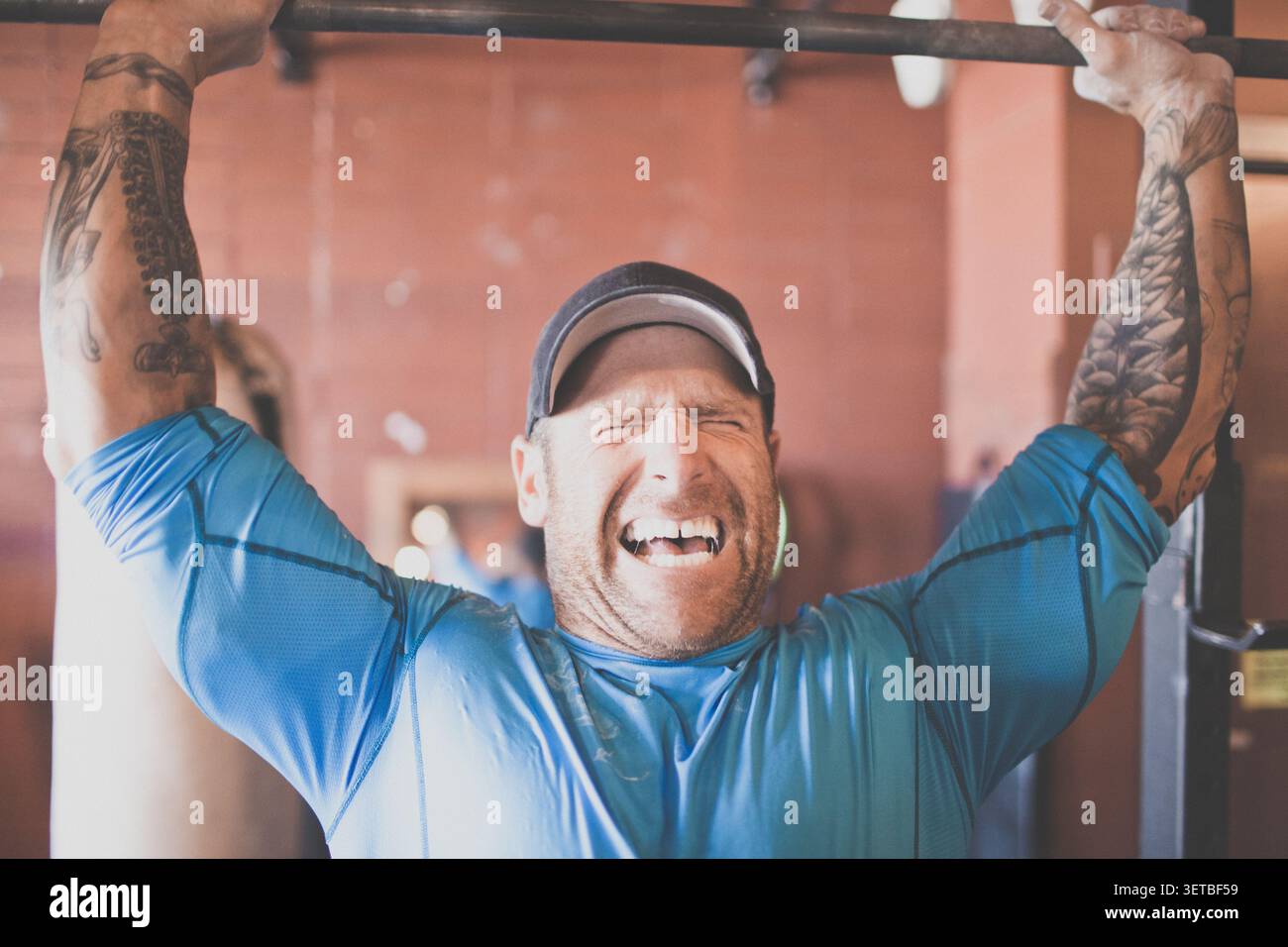 Adam Palmer, a mountain athlete, lifts weights at the gym during a ...
