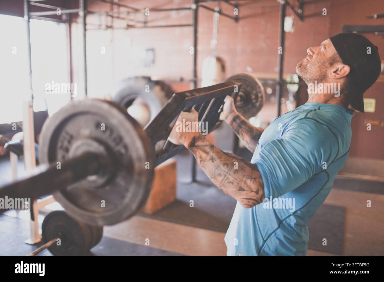 Adam Palmer, a mountain athlete, preforms bicep curls at the gym during ...