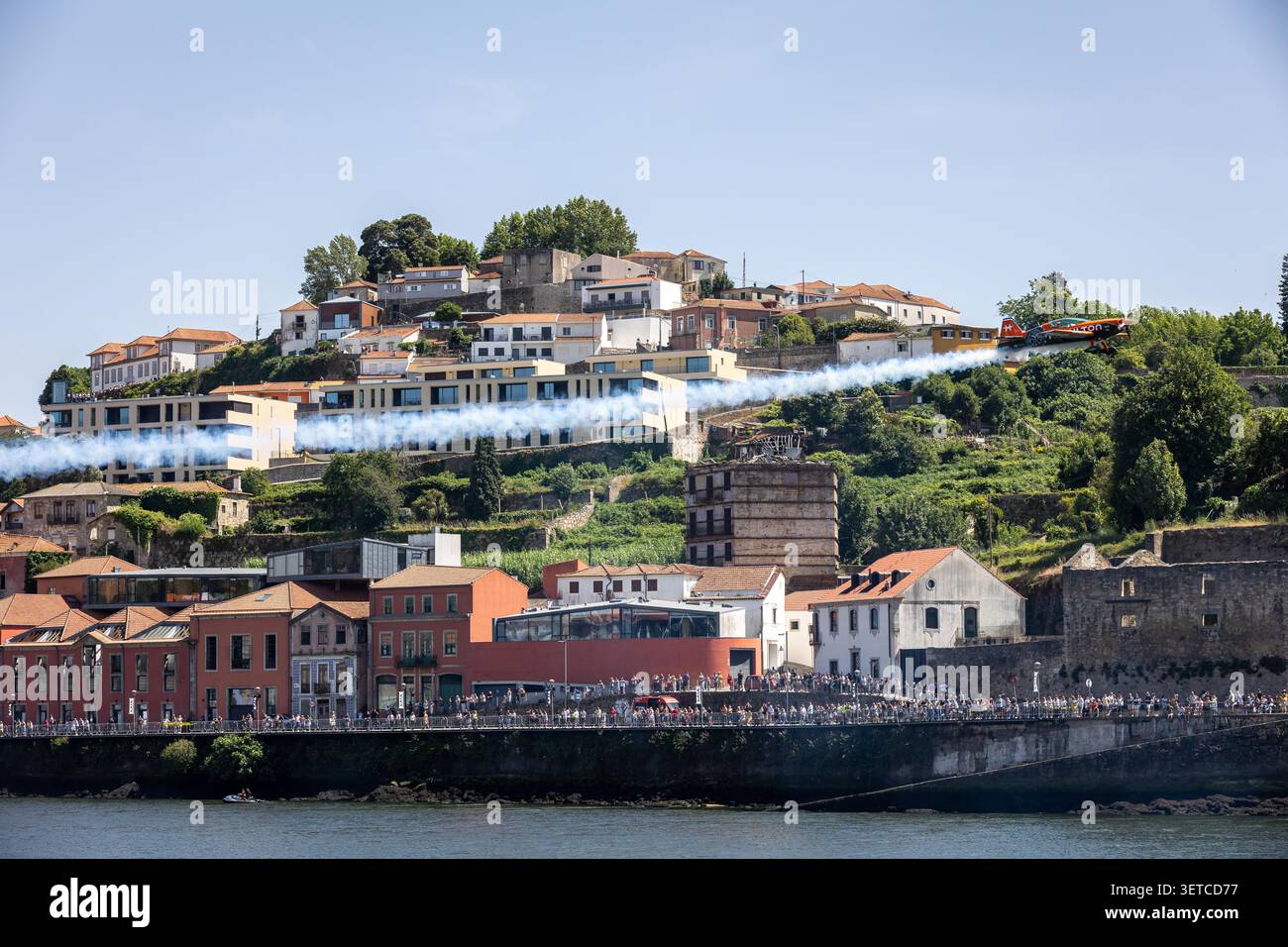 A Hamilton?branded aerobatic aircraft flies over the Douro River during ...