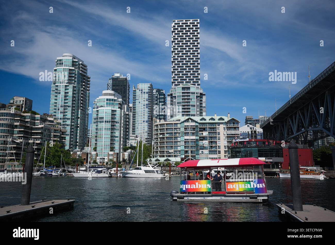 An Aquabus water taxi carrying tourists prepares to dock at Granville ...