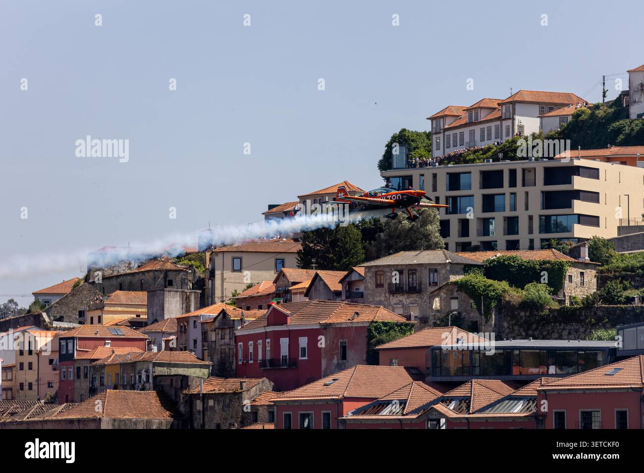 PA Hamilton?branded aerobatic aircraft flies low over the rooftops of ...