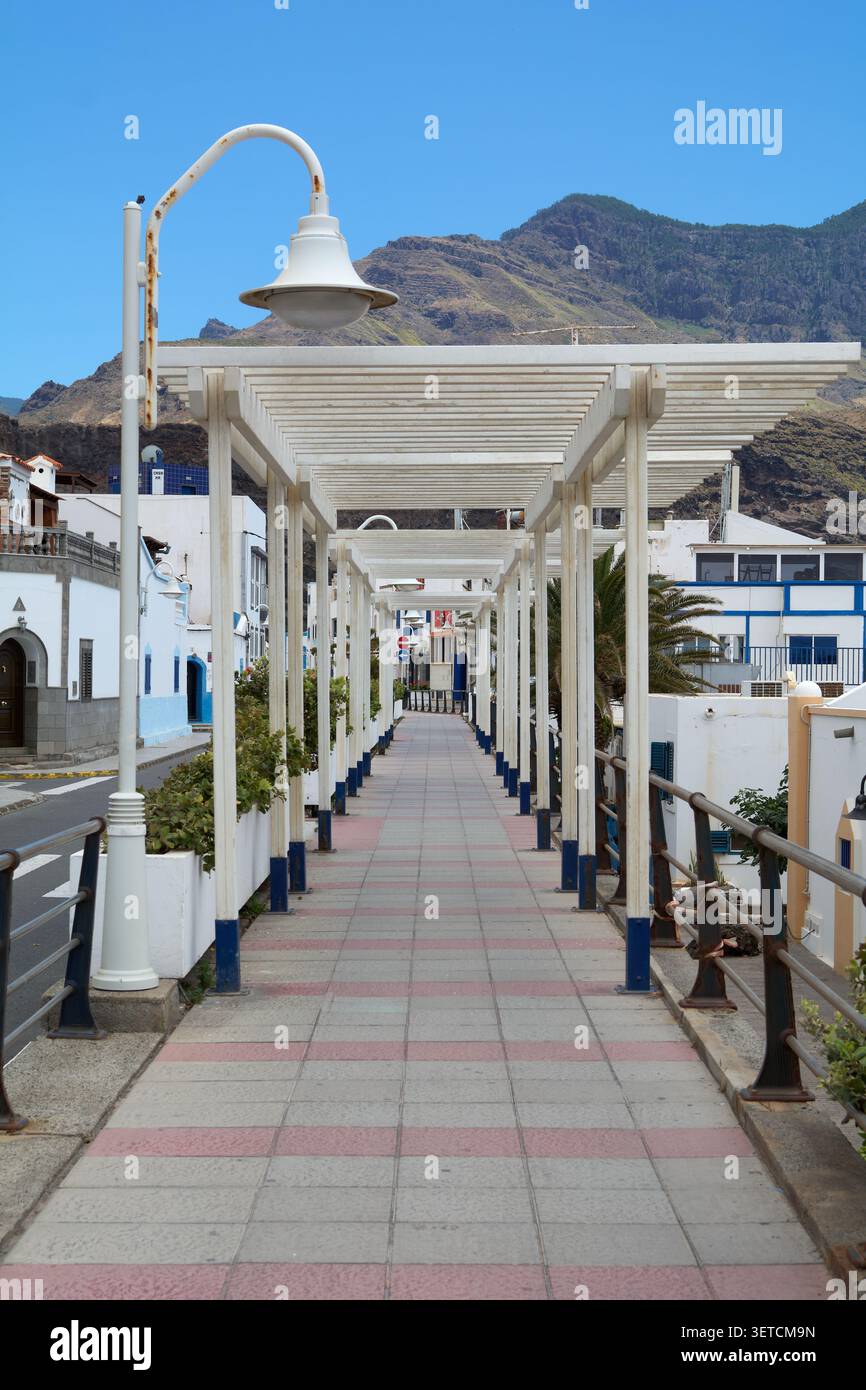 Agaete, Spain - June 22, 2026: Empty pedestrian path with a white ...