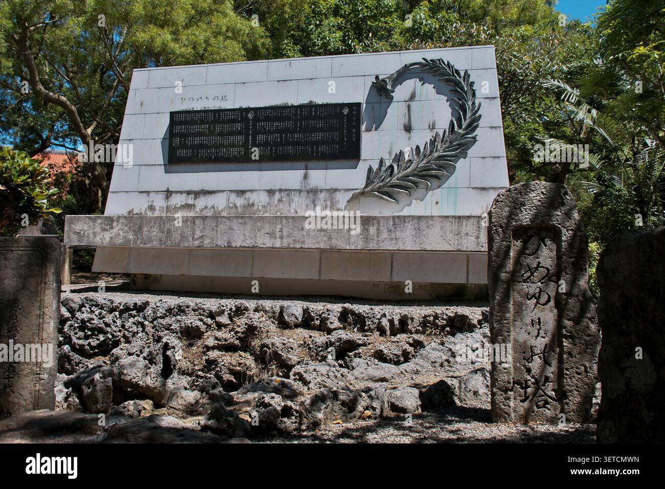 Visitors offer flowers and pray at the Himeyuri cenotaph by a cave in ...