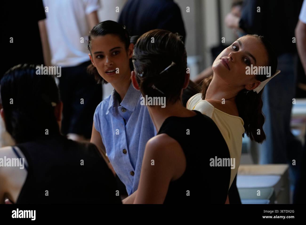 Models pose for photos as they wait for the start of Giorgio Armani's ...