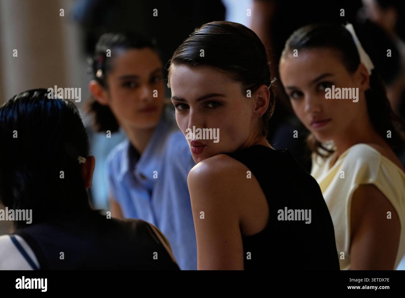 Models pose for photos as they wait for the start of Giorgio Armani's ...