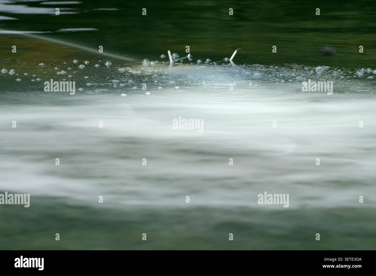 Bubbles emanate from a hose in the Lincoln Memorial Reflecting Pool ...