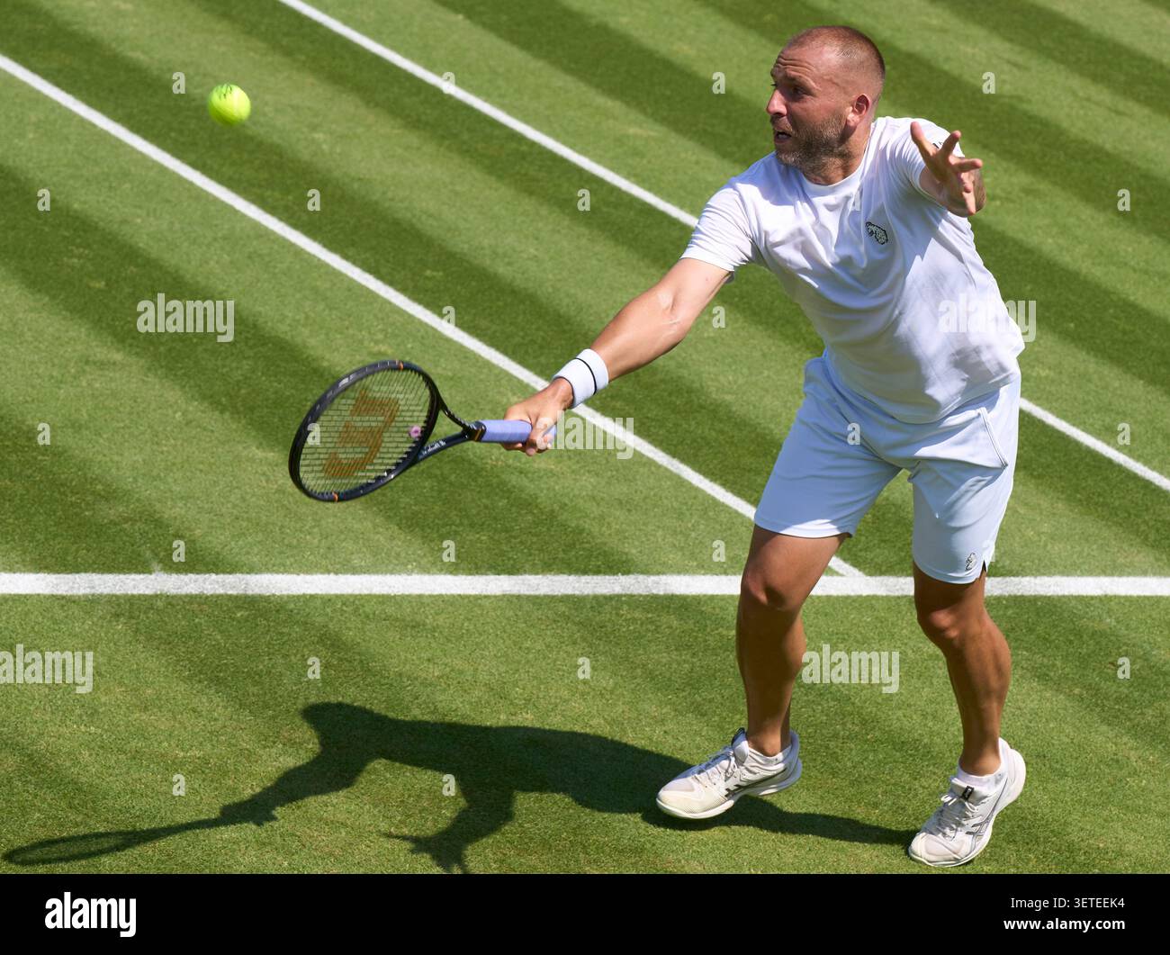 LONDON, - JUNE 22: Dan Evans in his final Wimbledon plays a backhand ...